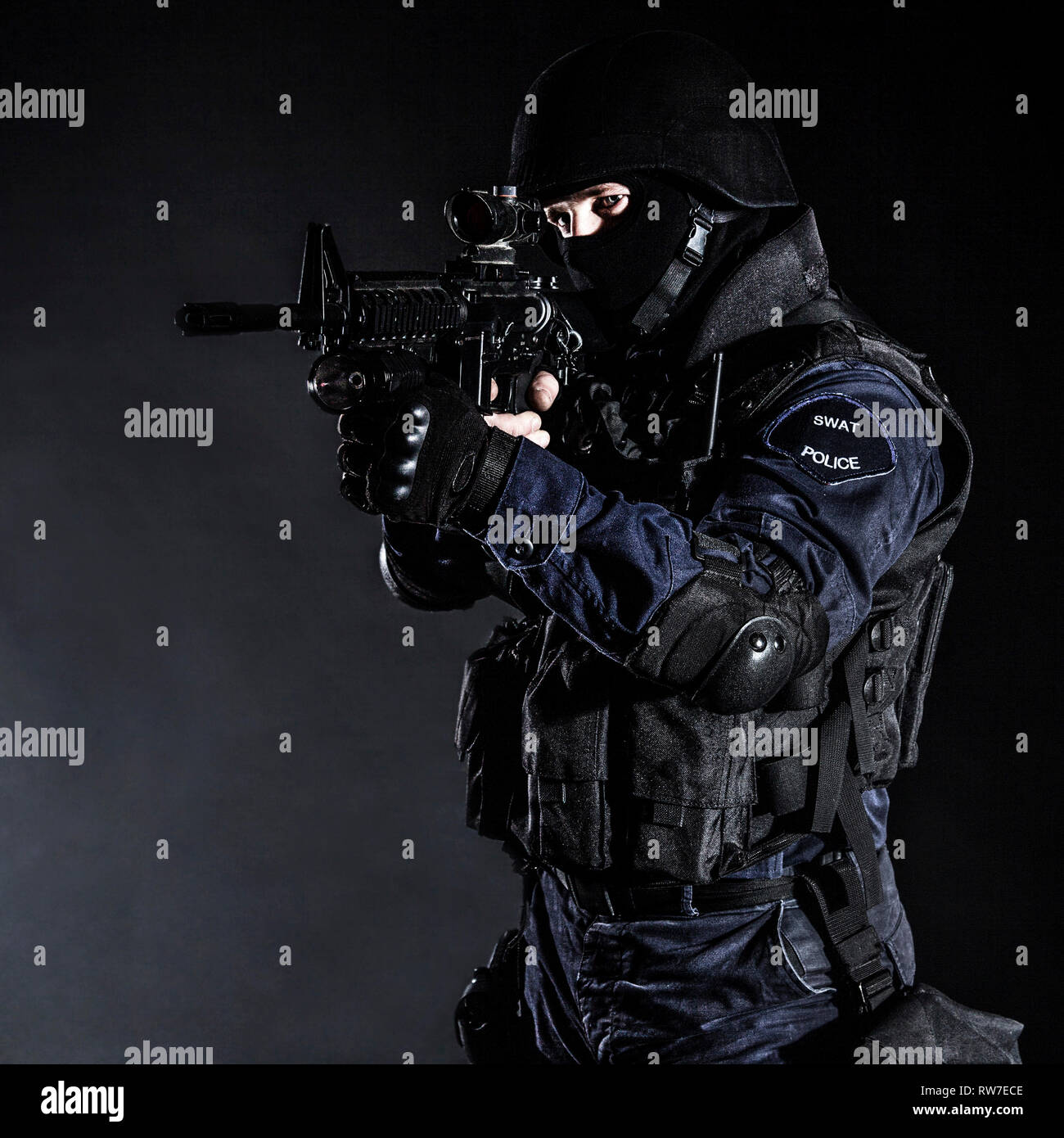 Special weapons and tactics (SWAT) team officer on black background ...