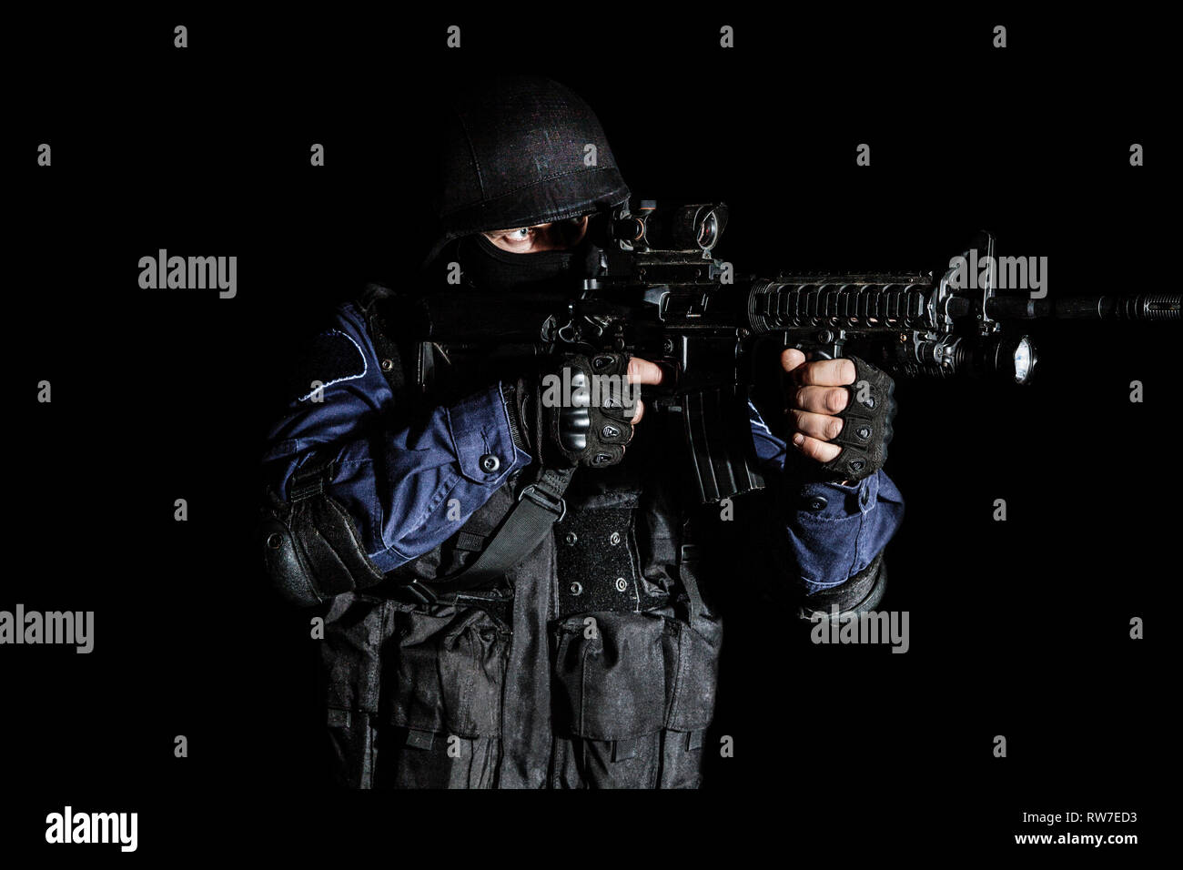 Special weapons and tactics (SWAT) team officer on black background ...