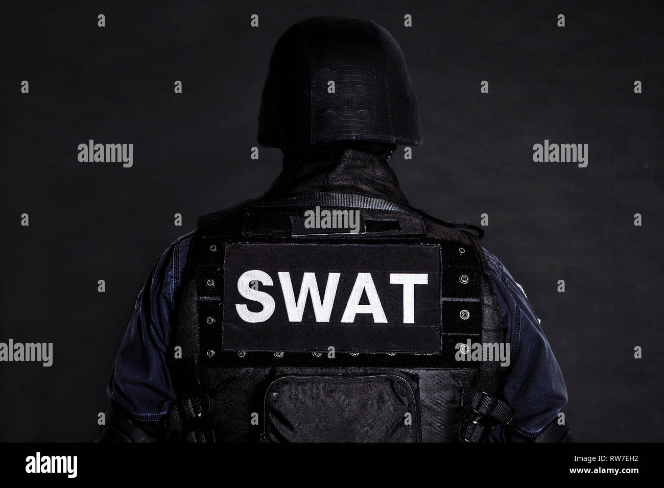 Special weapons and tactics (SWAT) team officer on black background ...