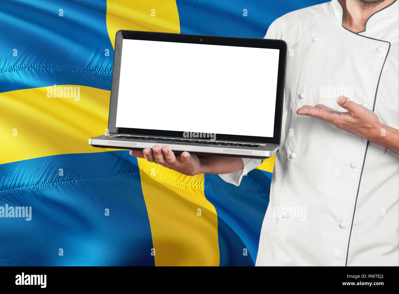 Swedish Chef holding laptop with blank screen on Sweden flag background ...