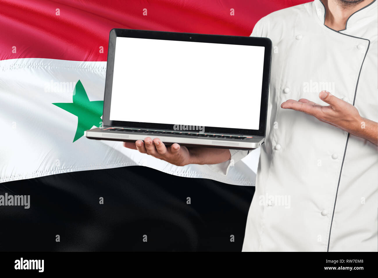 Syrian Chef holding laptop with blank screen on Syria flag background ...
