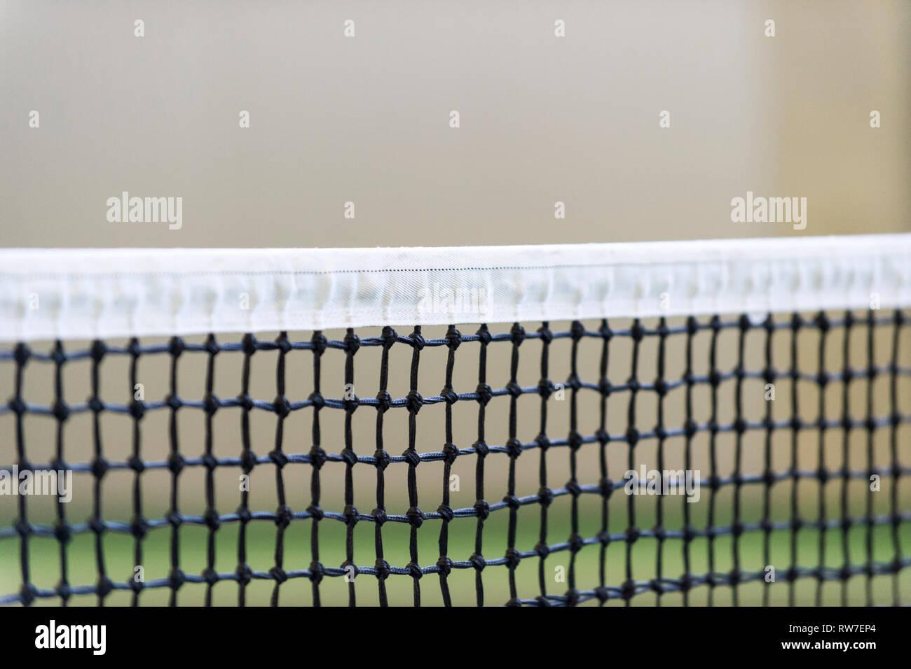 Net of tennis court on gray wall background Stock Photo - Alamy