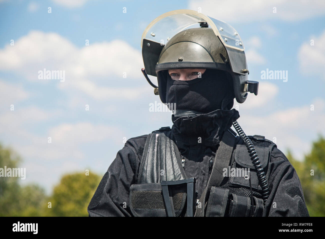Spec ops soldier in black uniform and face mask with his rifle Stock ...