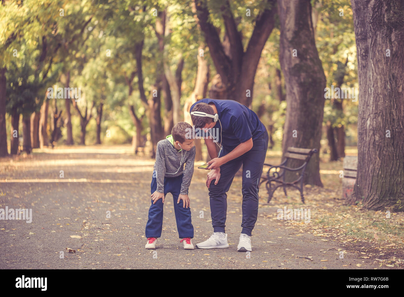 Little boy and his father taking a break and listening to the music ...