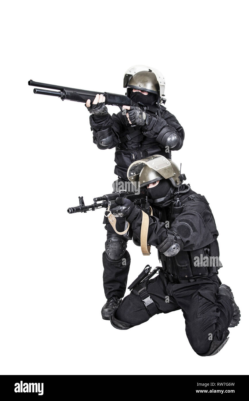 Two spec ops soldiers in black uniform in action Stock Photo - Alamy
