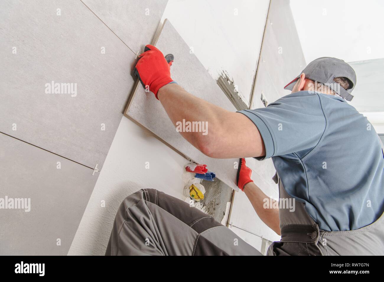 Caucasian Ceramic Tiles Installer in His 30s Creating Brand New Wall of ...