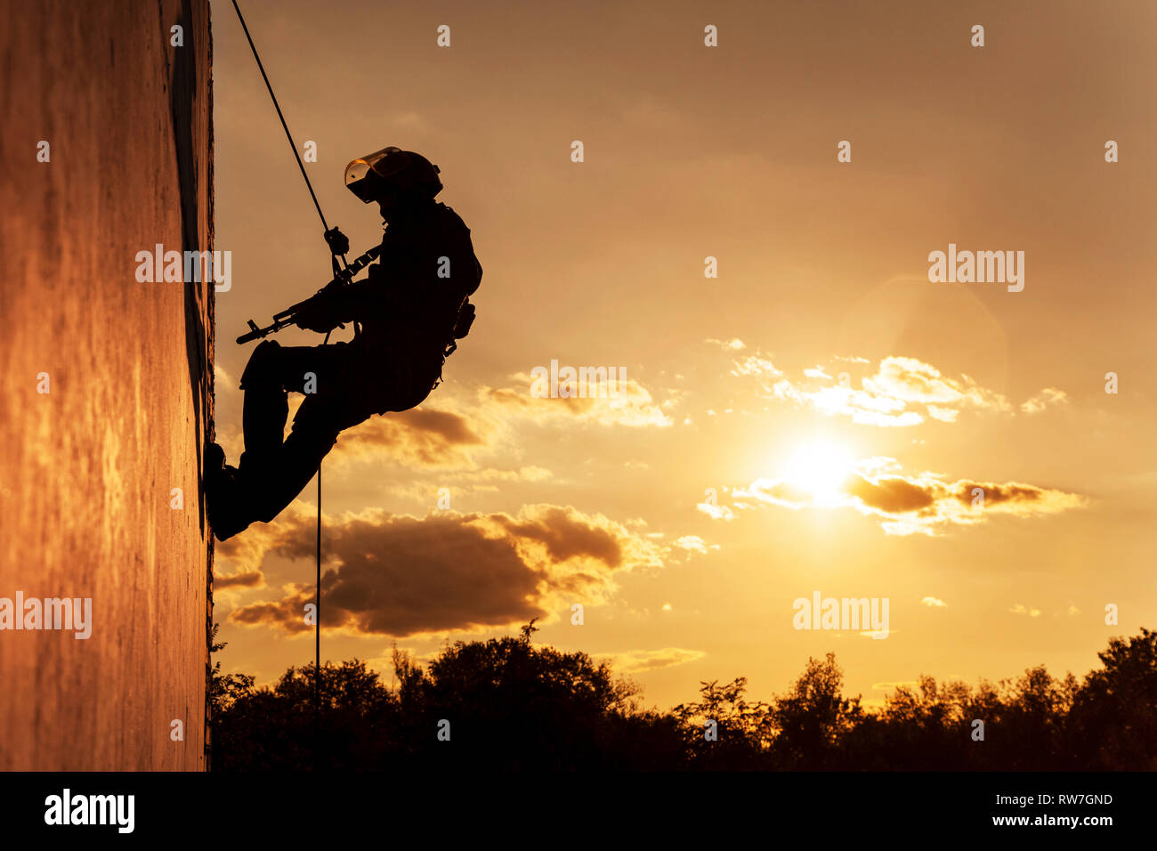 Silhouette of police officer during rope exercises with weapons Stock ...