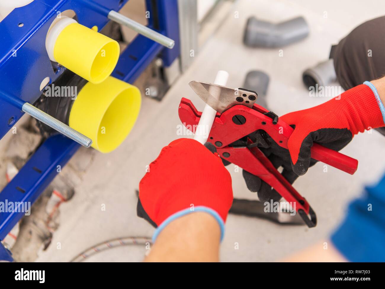 Sanitary Plumbing Job. Caucasian Plumber with Plastic Pipe Scissors in ...