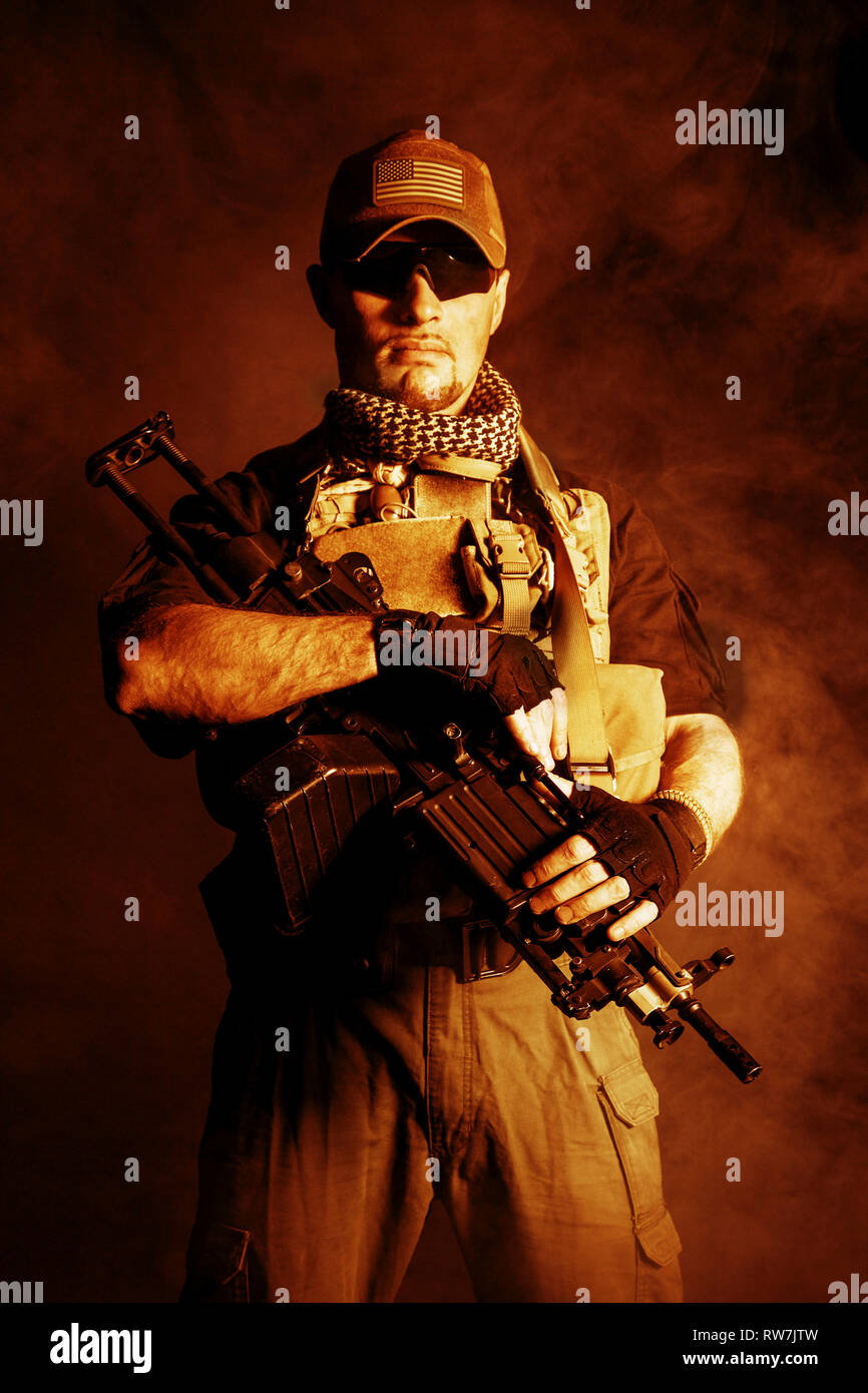 Private military contractor PMC with assault rifle on dark background ...