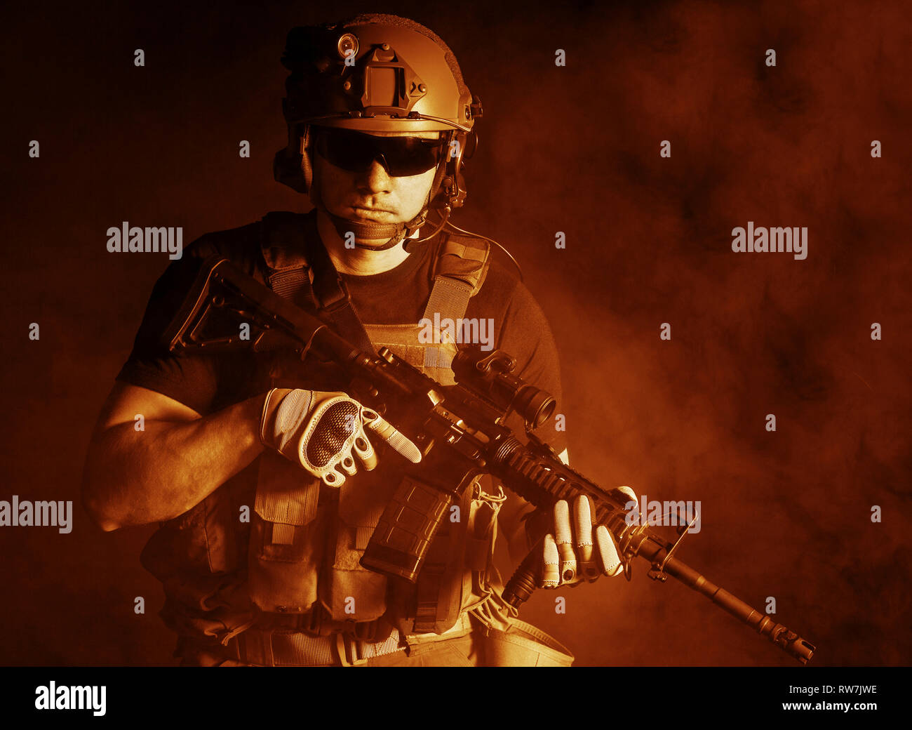 Private military contractor PMC with assault rifle on dark background ...