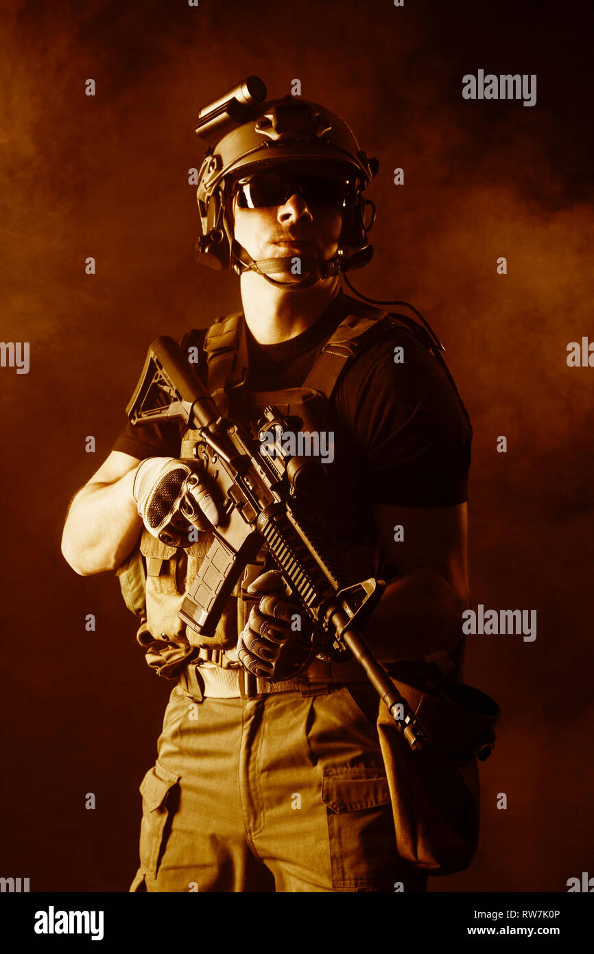 Private military contractor PMC with assault rifle on dark background ...
