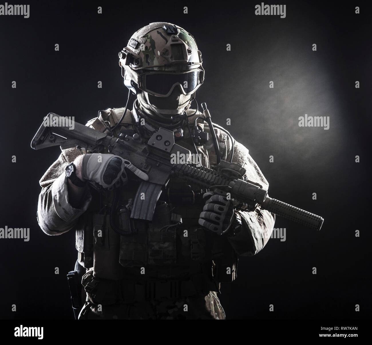 Special forces soldier with rifle on dark background Stock Photo - Alamy