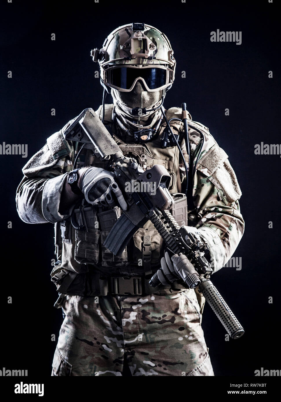 Special forces soldier with rifle on dark background Stock Photo - Alamy