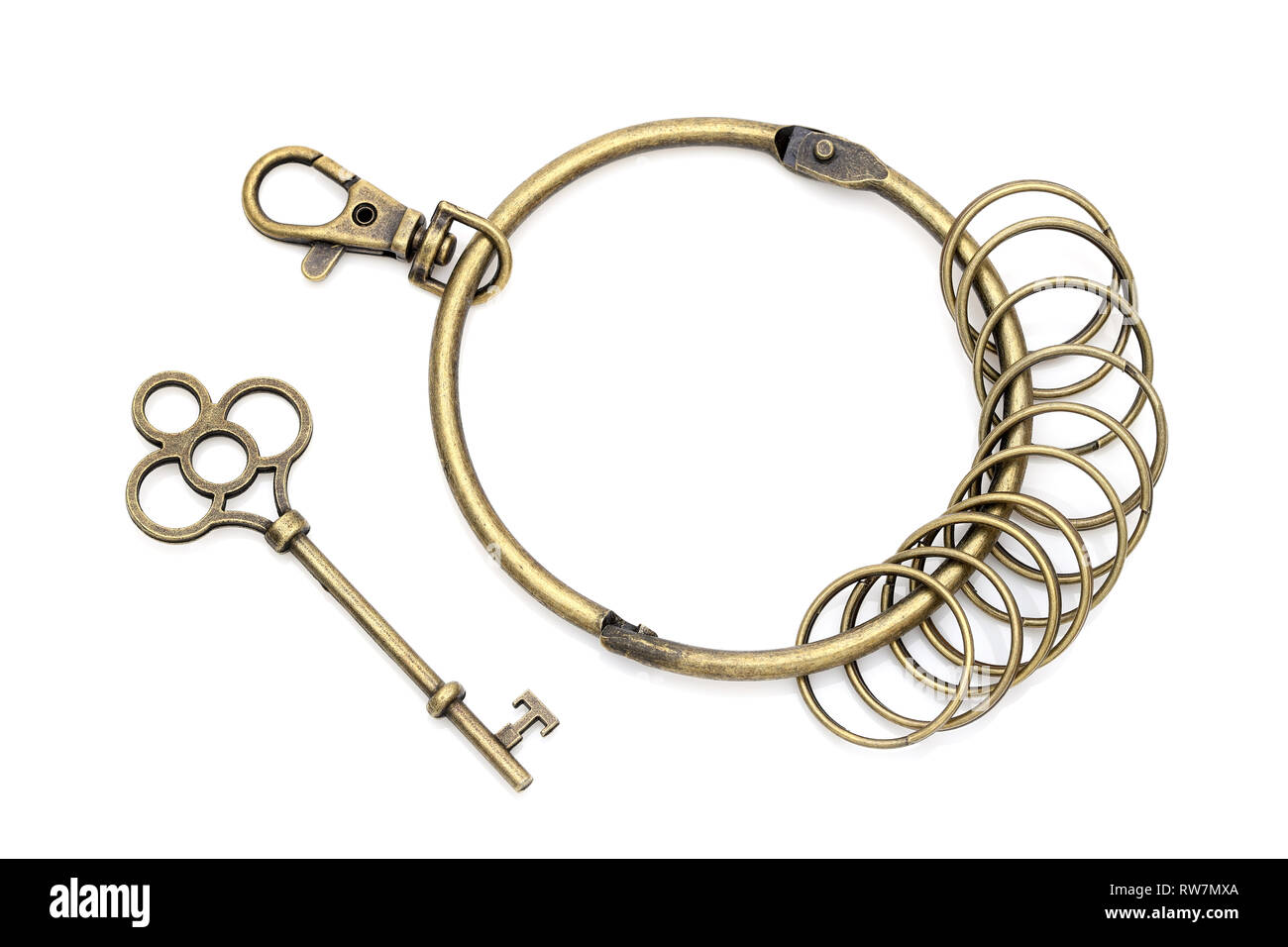 brass key ring with antique golden key on a white background Stock ...