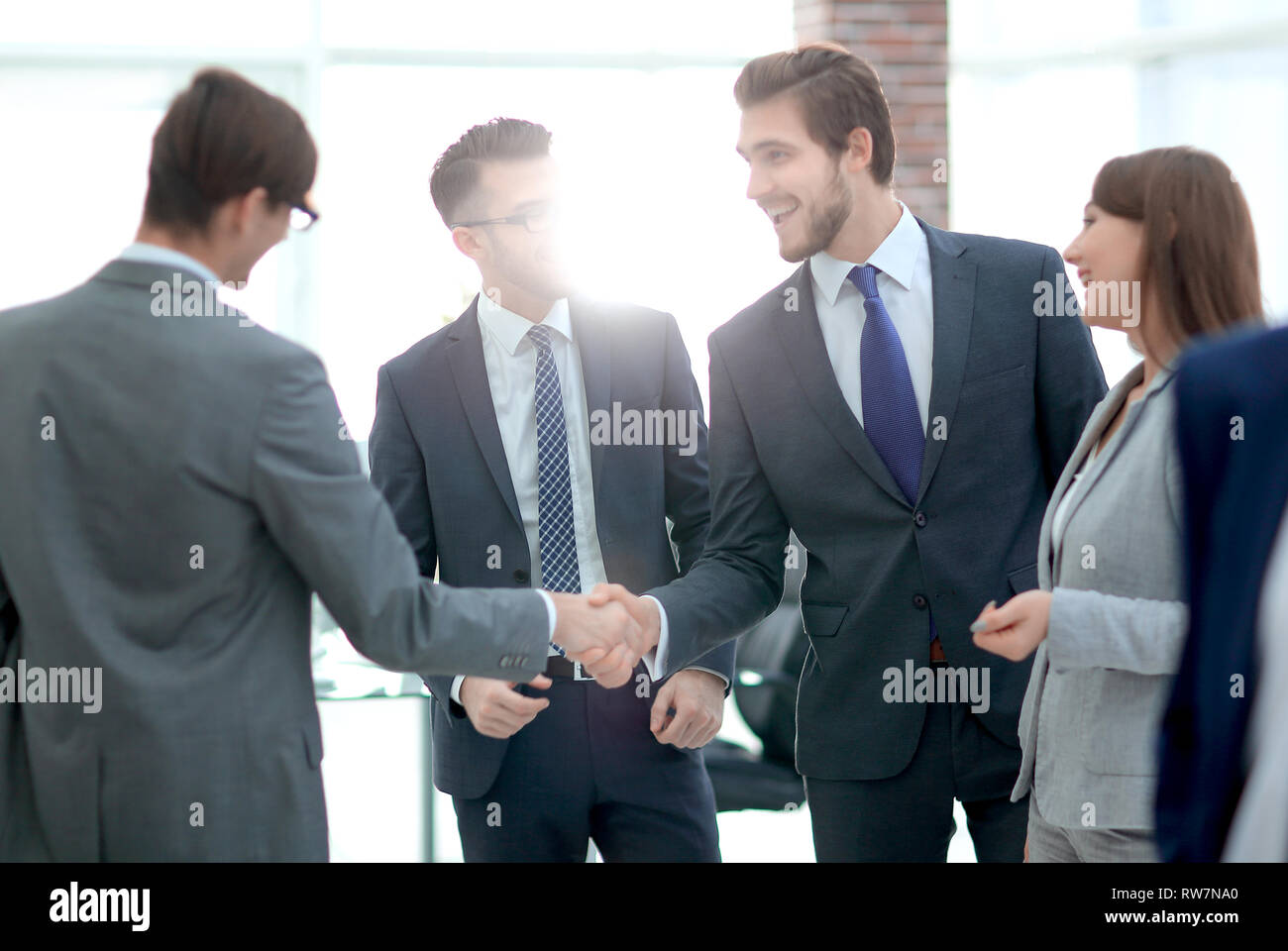 Confident young people, handshake and smile Stock Photo - Alamy