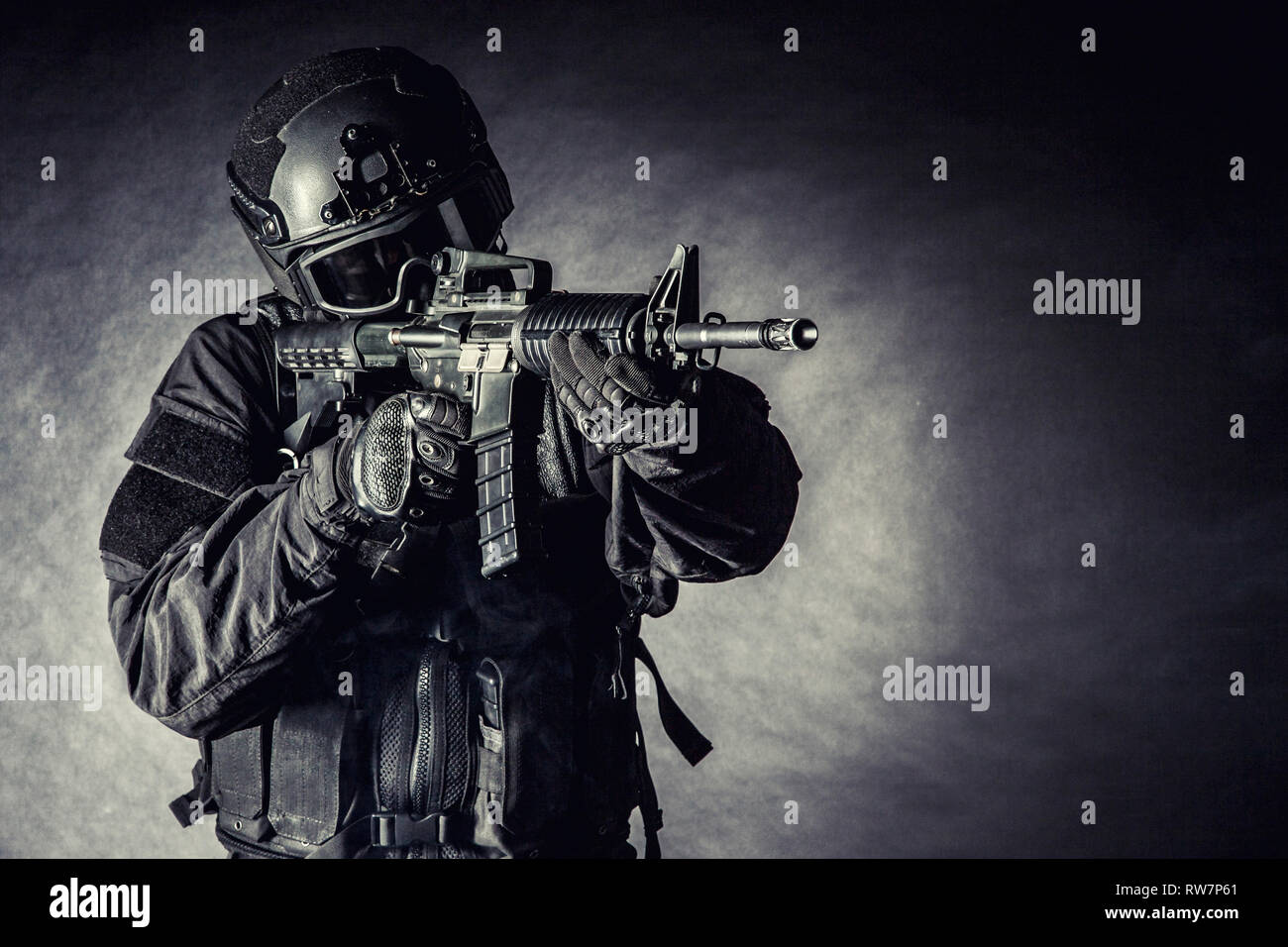 Spec ops police officer SWAT in black uniform and face mask Stock Photo ...