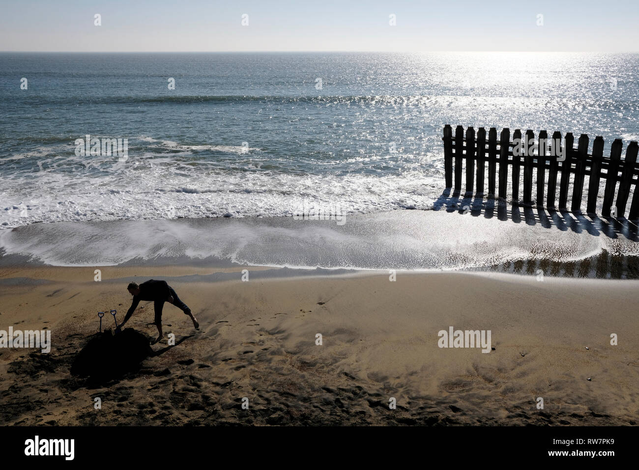 Man builds sand castle on Ventnor beach in winter, Ventnor, Isle of ...