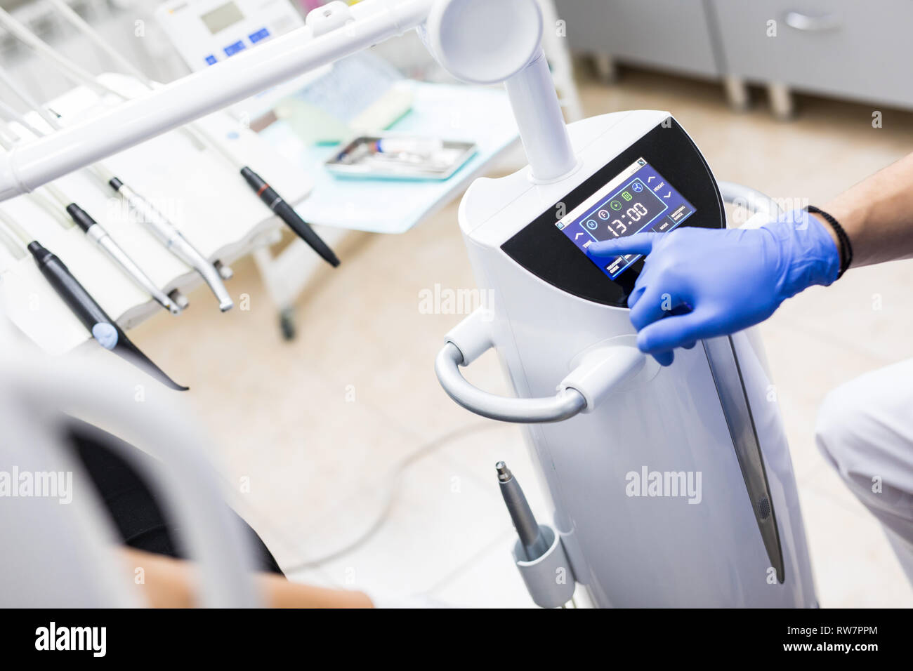 Man hand in gloves starting a teeth whitening machine, Newest Laser ...