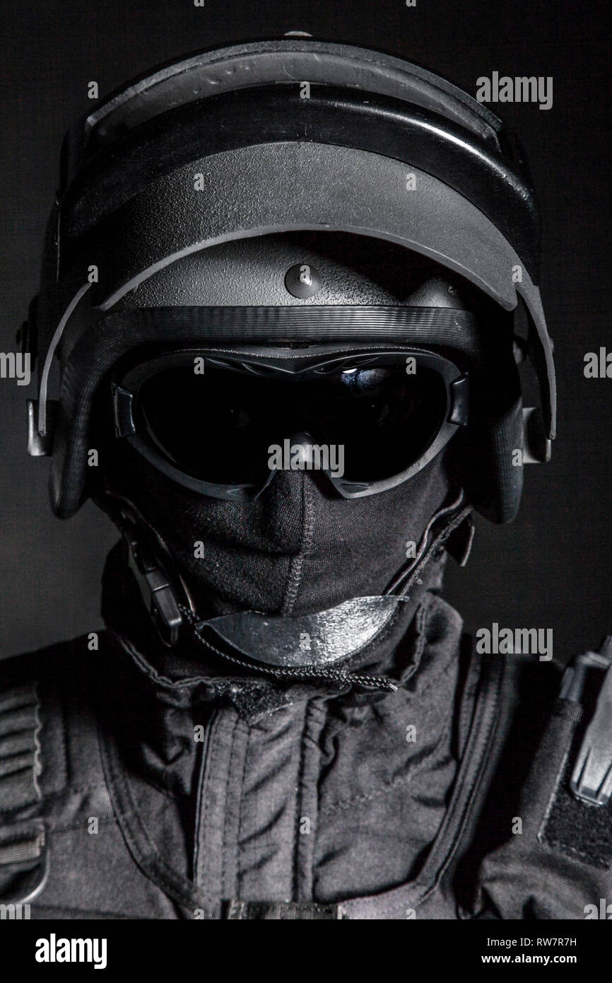 Russian special forces operator in black uniform and bulletproof helmet ...