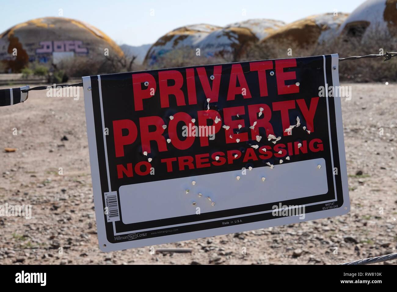A private poperty sign is riddled with bullets Stock Photo - Alamy