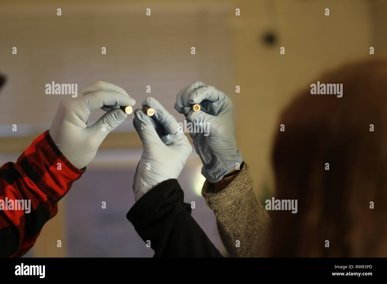 Investigators examine bullet shells at crime scene Stock Photo - Alamy
