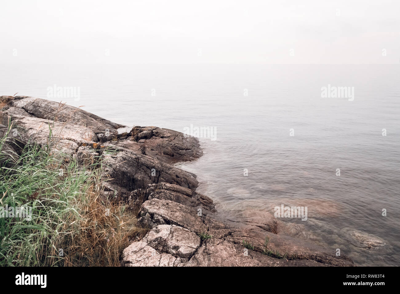 Rocky coast and smooth water. Scandinavian nature - calm lake Stock ...