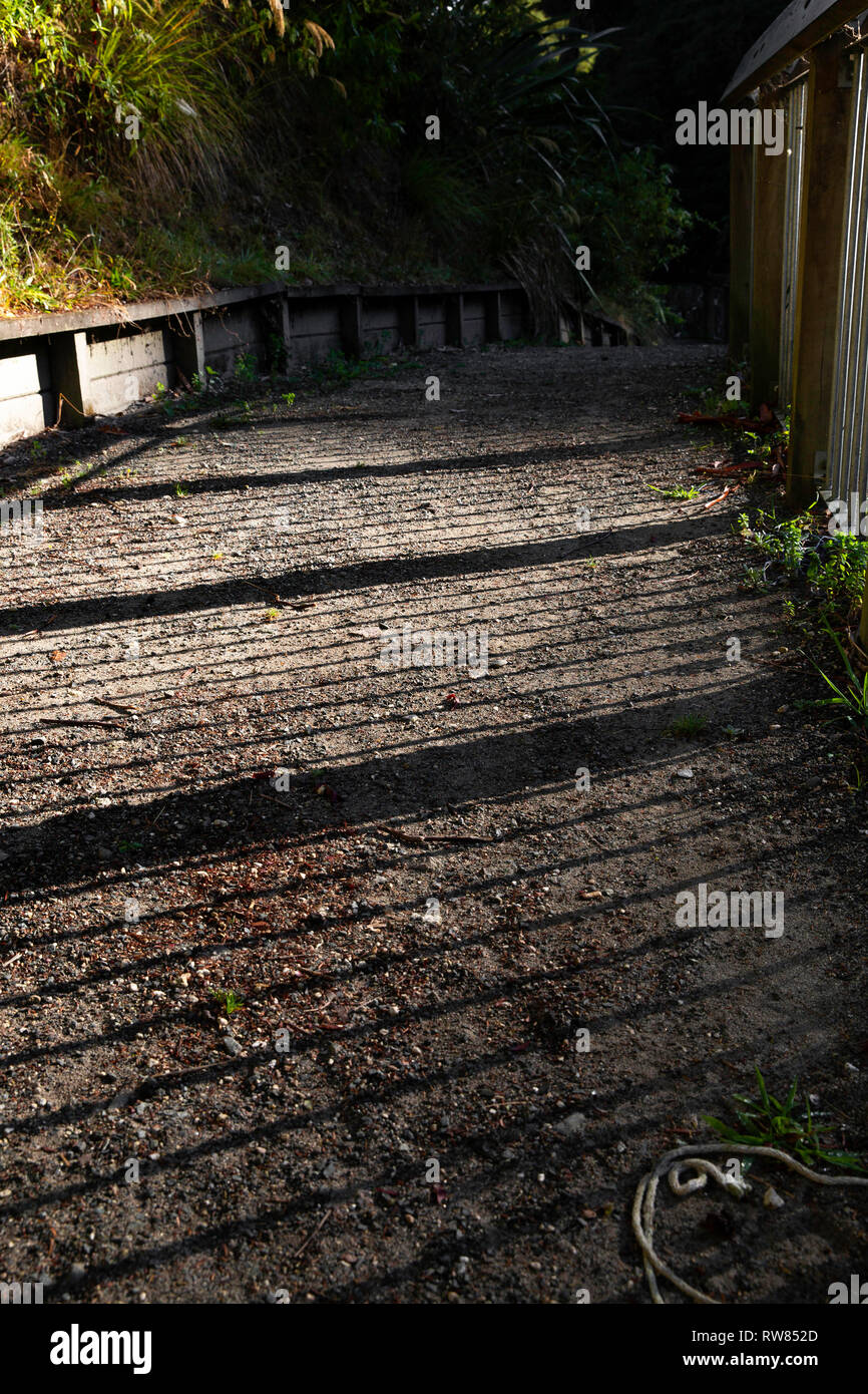 Shadowed path with creative patterns made by the sun shining through ...