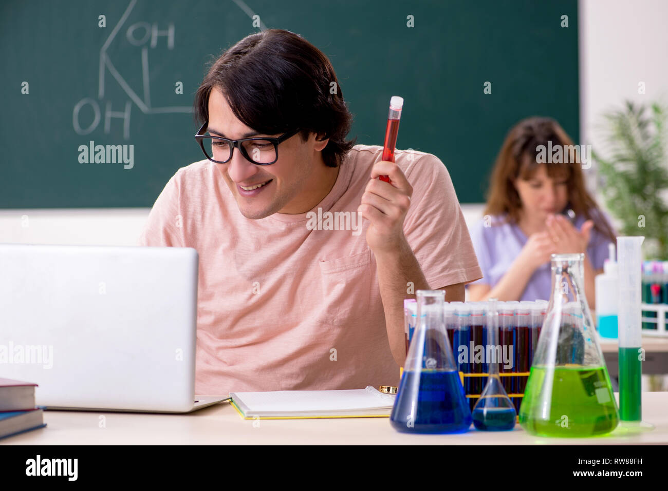 Two chemists students in classroom Stock Photo - Alamy