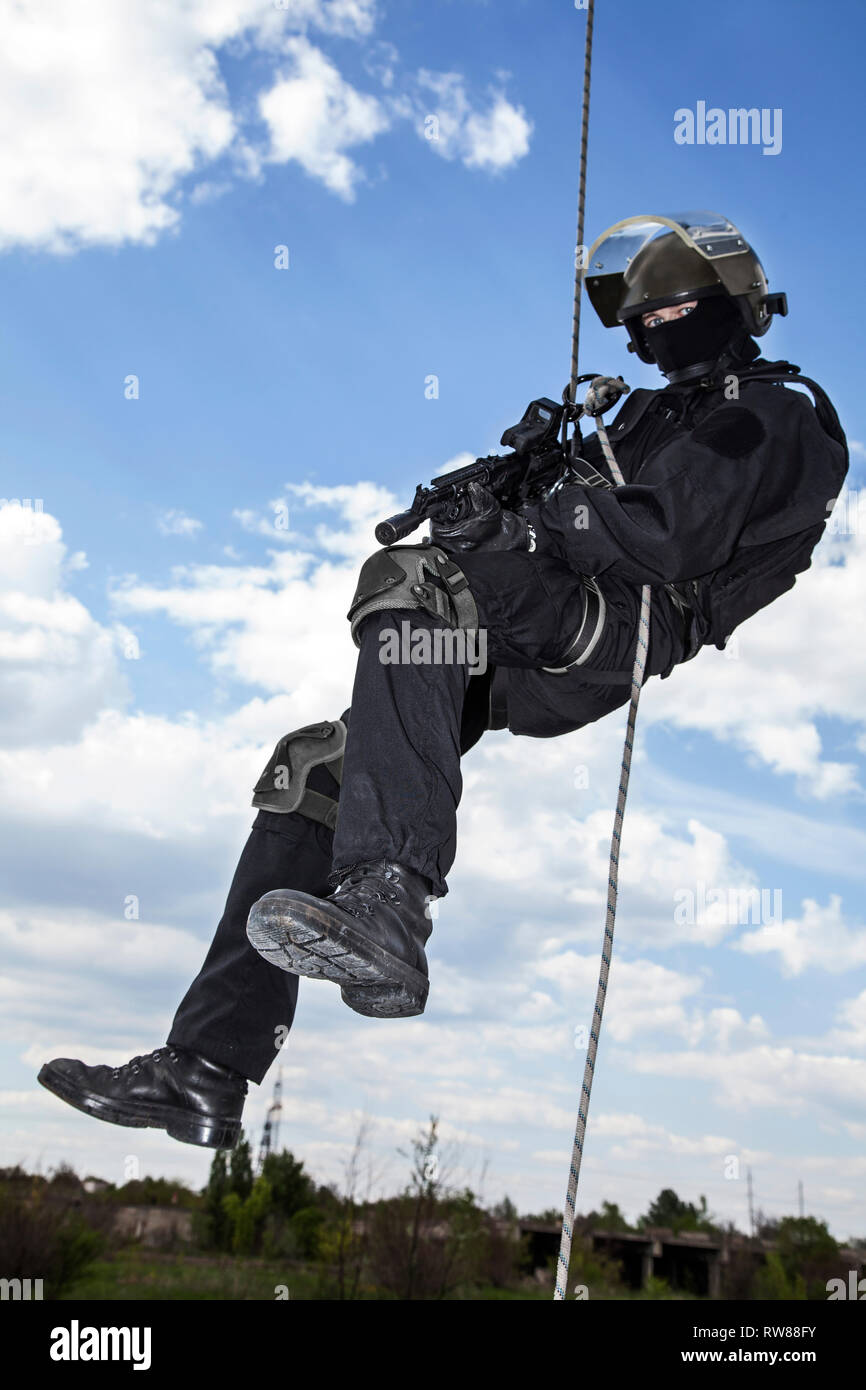 Special forces operator during assault rappelling with weapons Stock ...
