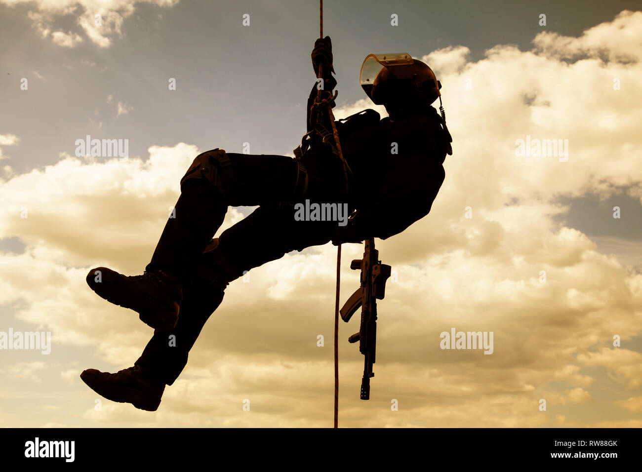 Special forces operator during assault rappelling with weapons Stock ...