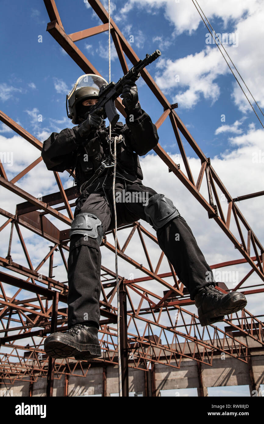 Special forces operator rappelling with weapons during an assault Stock ...