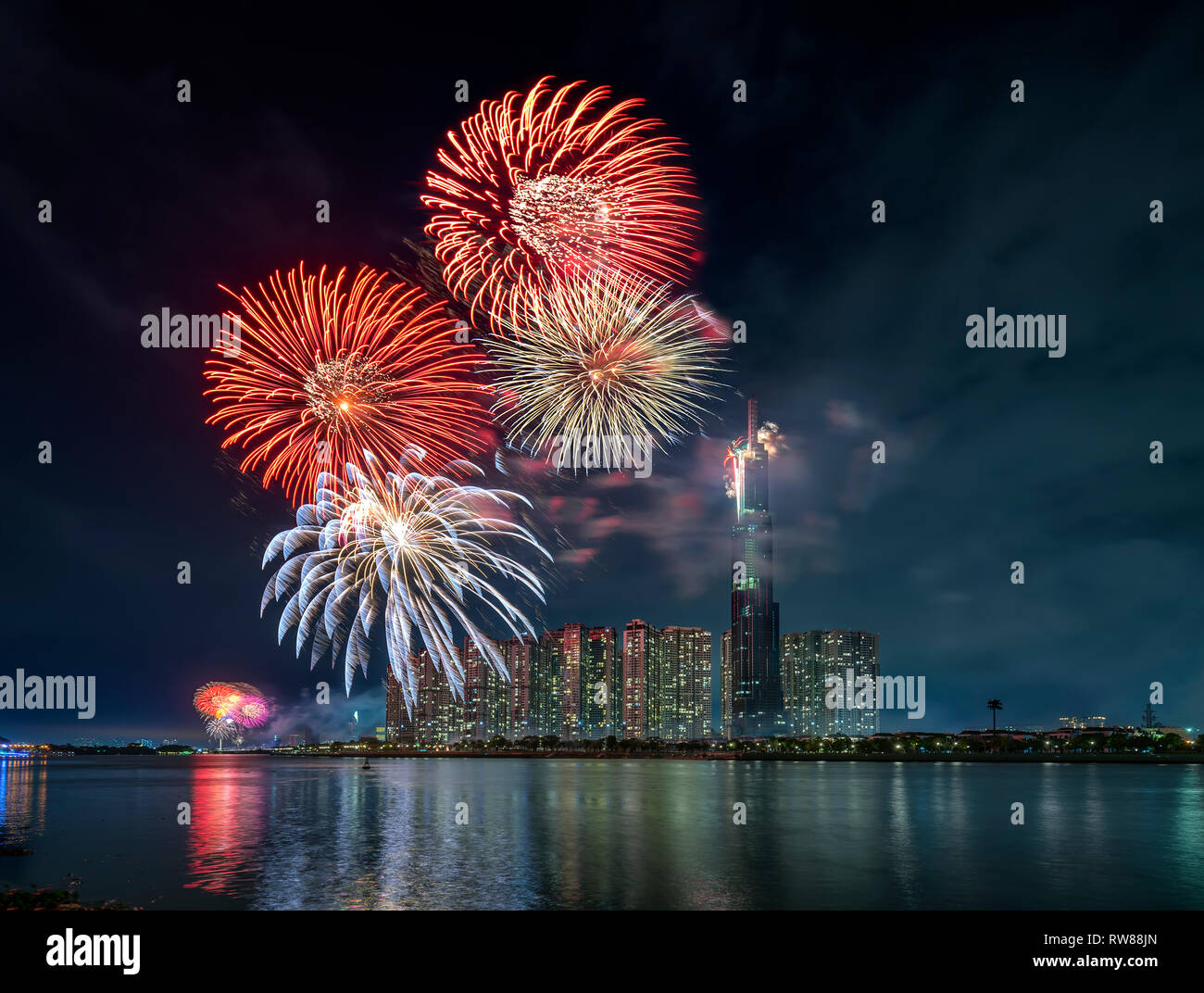 Colorful fireworks in the sky glowing at night beside the skyscraper in ...