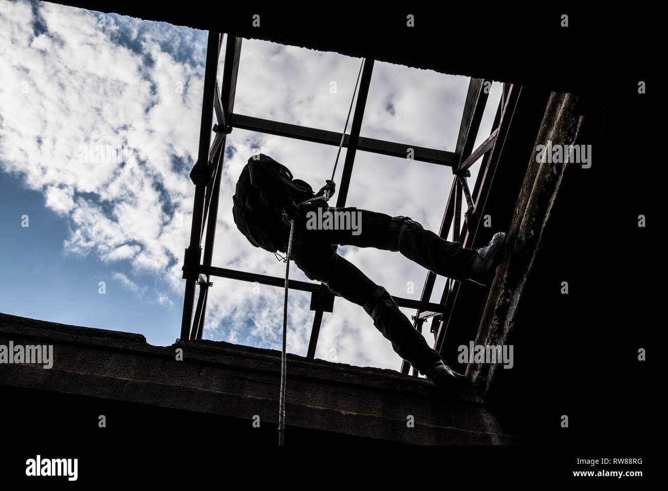 Special forces operator during assault rappelling with weapons Stock ...