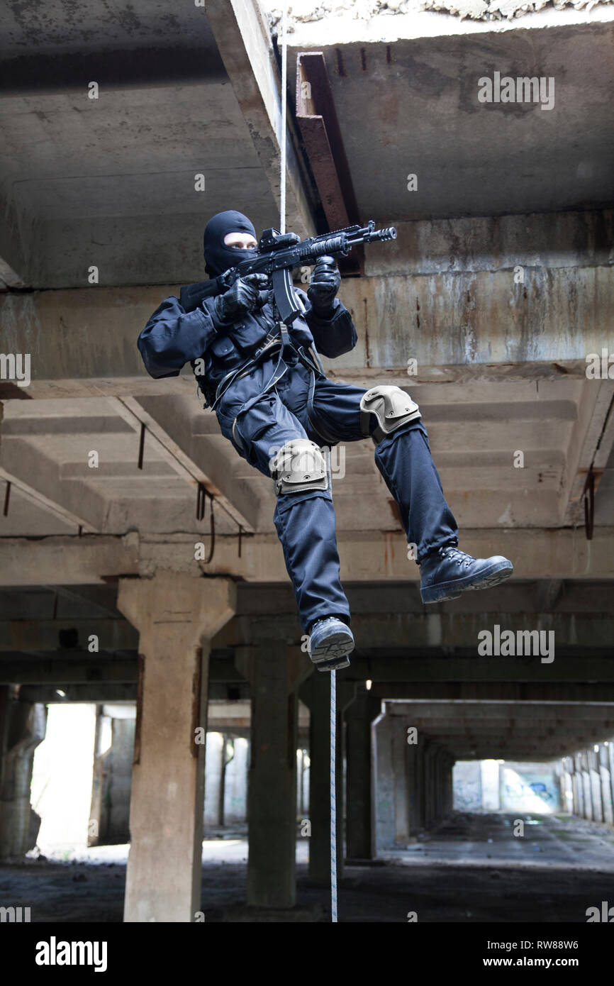 Special forces operator during assault rappelling with weapons Stock ...