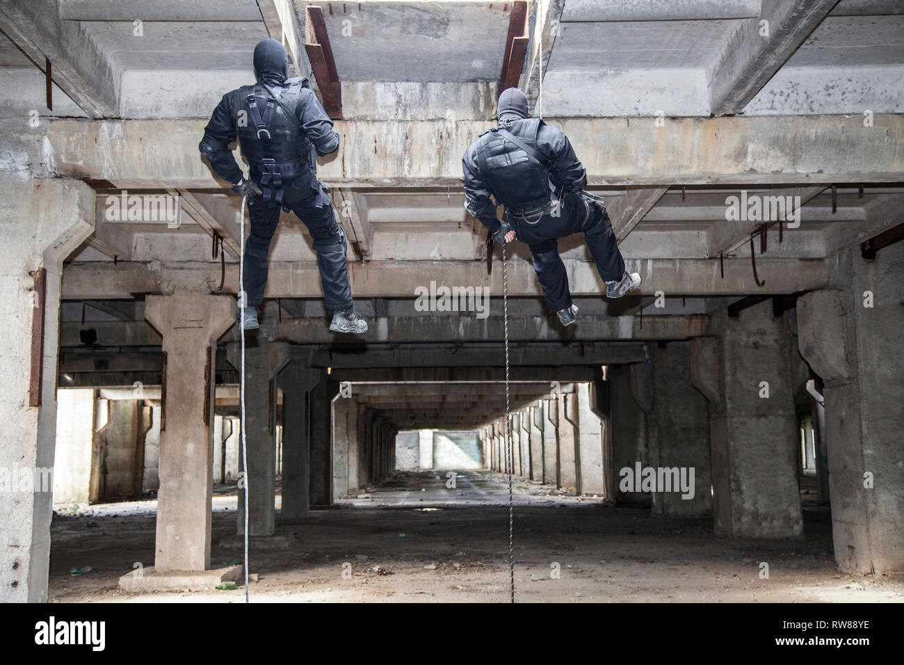 Special forces operators during assault rappelling with weapons Stock ...