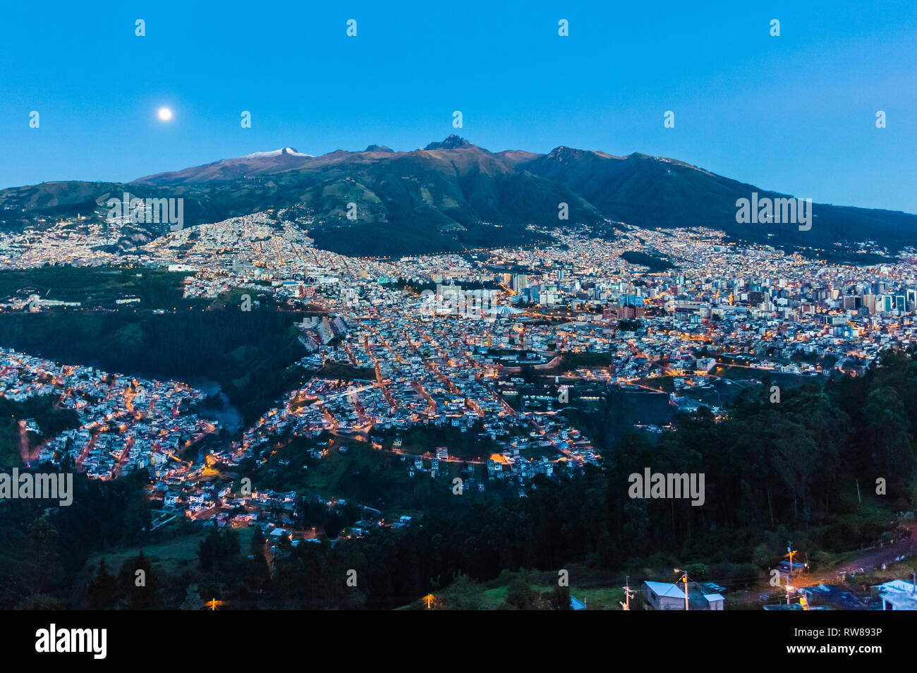 Quito, capital of Ecuador, before dawn with the diffuse moon on the ...