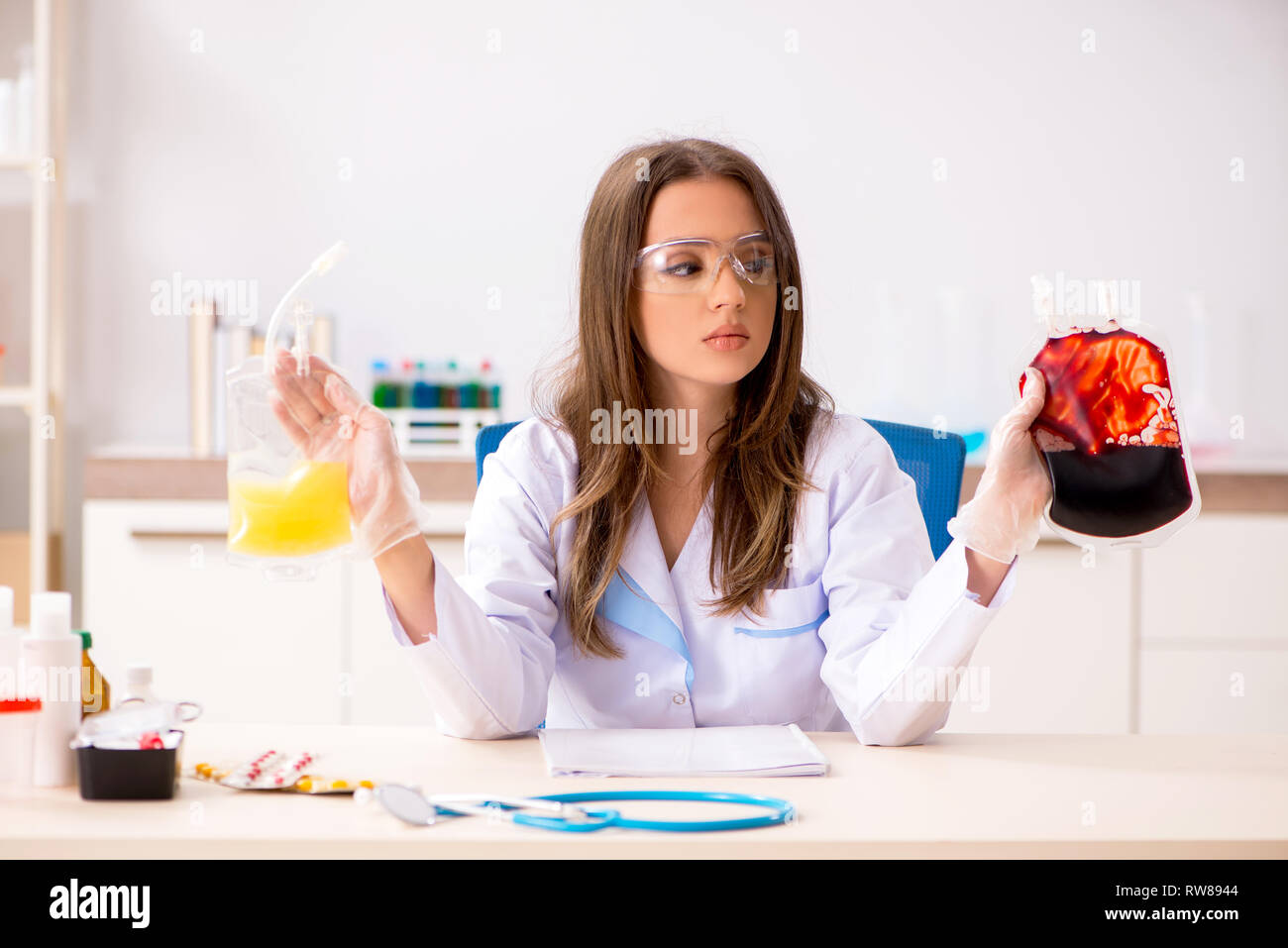 Female assistant with bag of blood in the lab Stock Photo - Alamy
