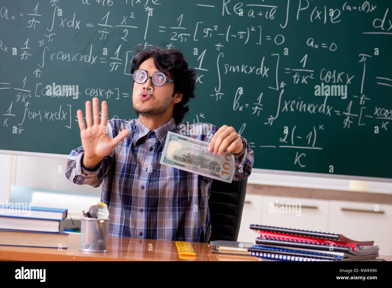 Funny male math teacher in the classroom Stock Photo - Alamy