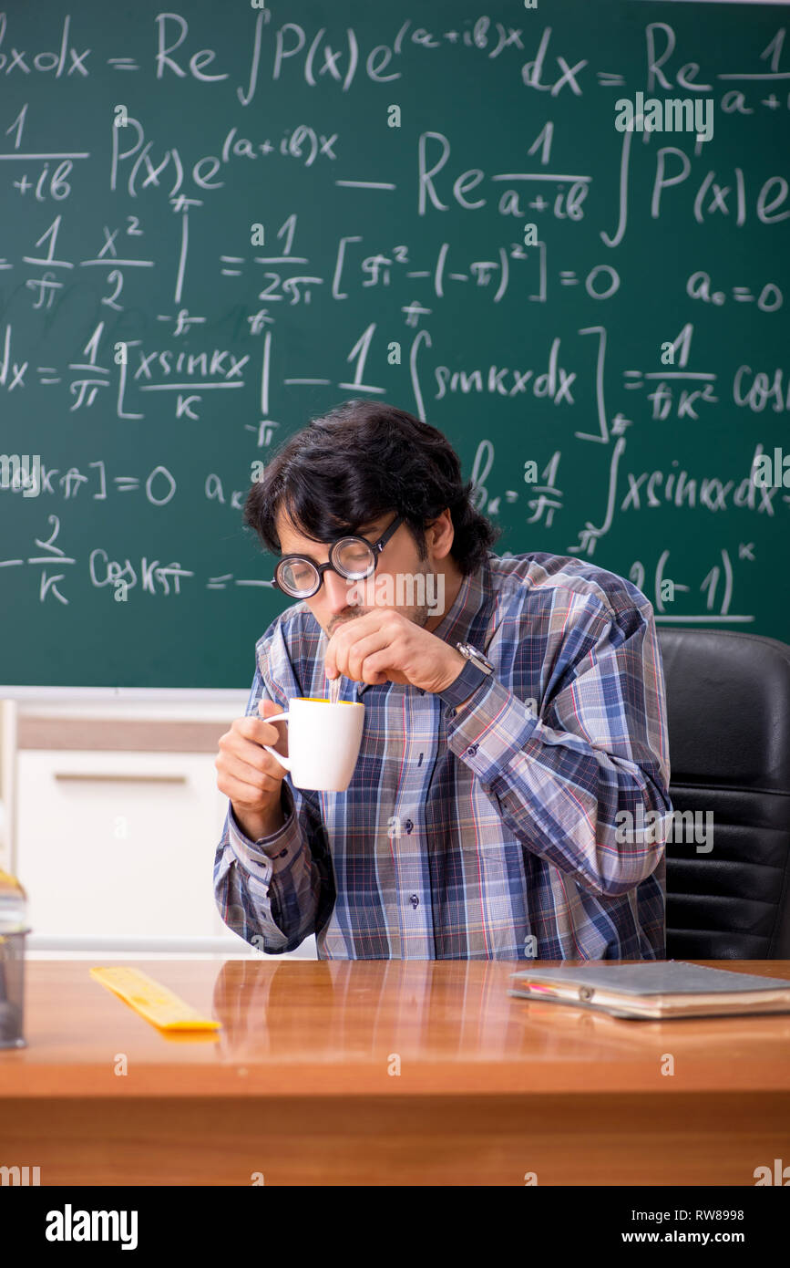 Funny male math teacher in the classroom Stock Photo - Alamy