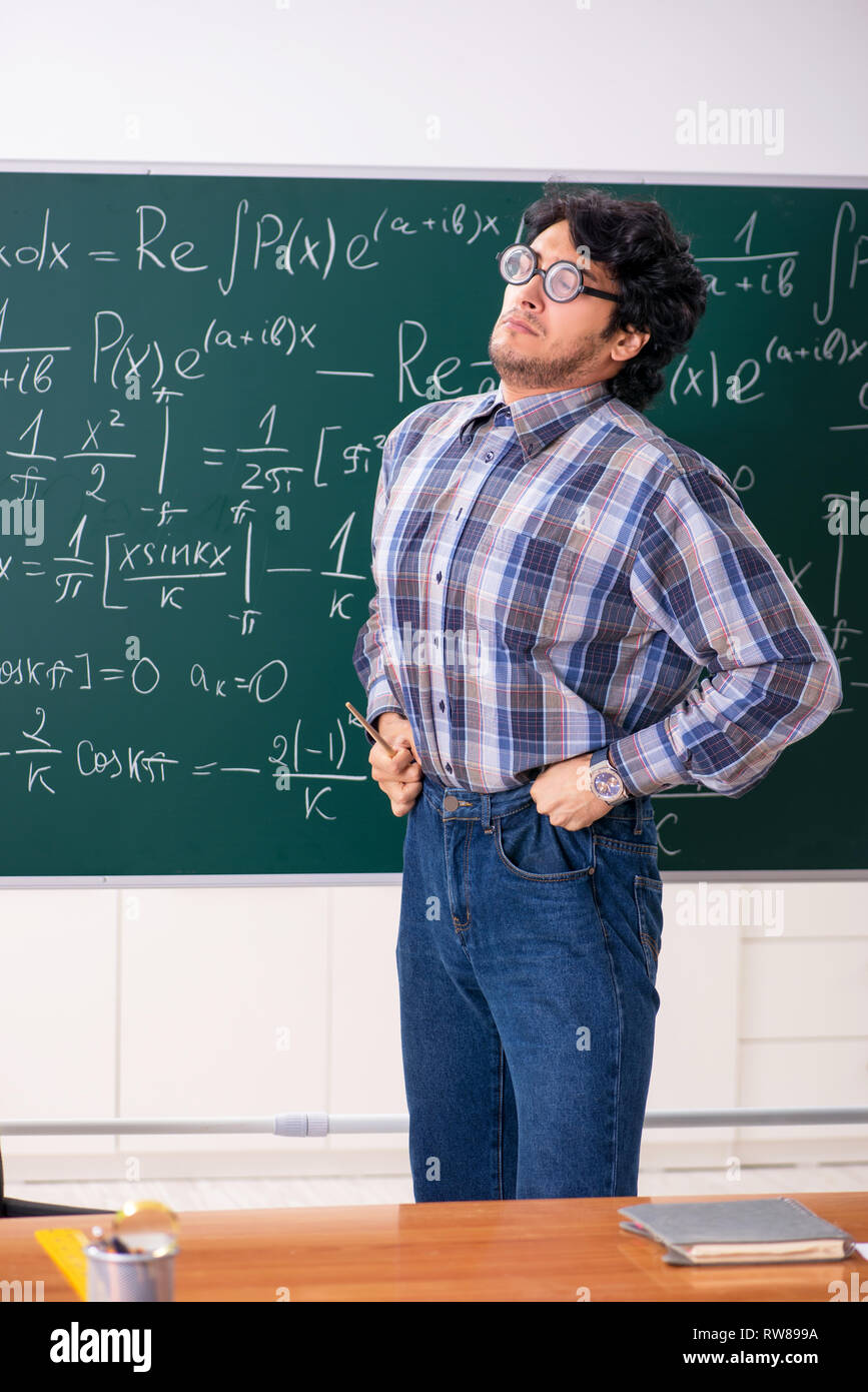 Funny male math teacher in the classroom Stock Photo - Alamy