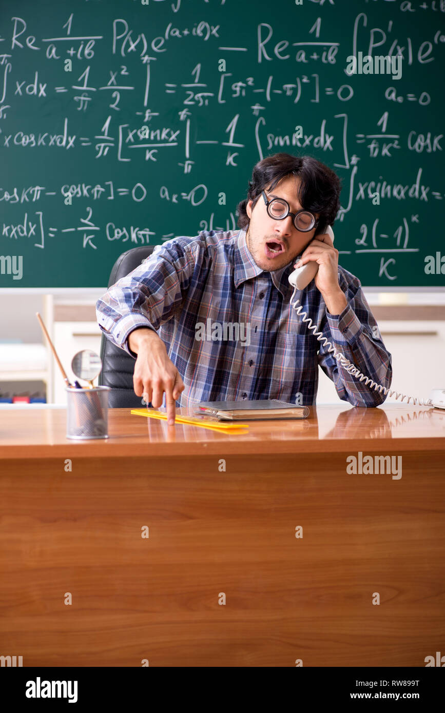 Funny male math teacher in the classroom Stock Photo - Alamy