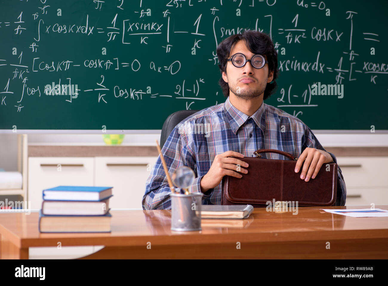 Funny male math teacher in the classroom Stock Photo - Alamy
