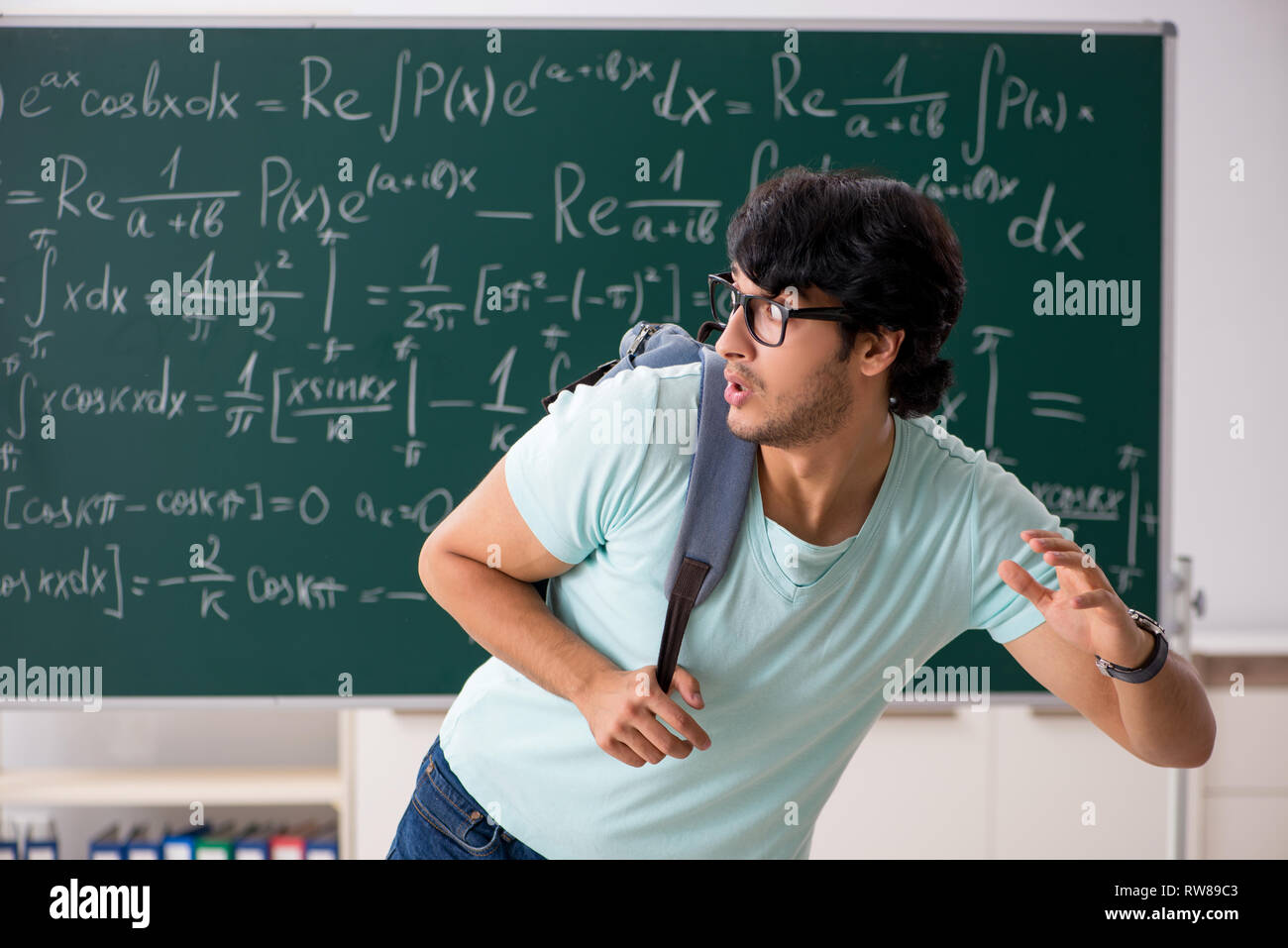 Young male student mathematician in front of chalkboard Stock Photo - Alamy