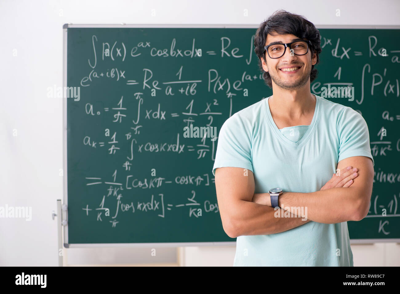 Young male student mathematician in front of chalkboard Stock Photo - Alamy