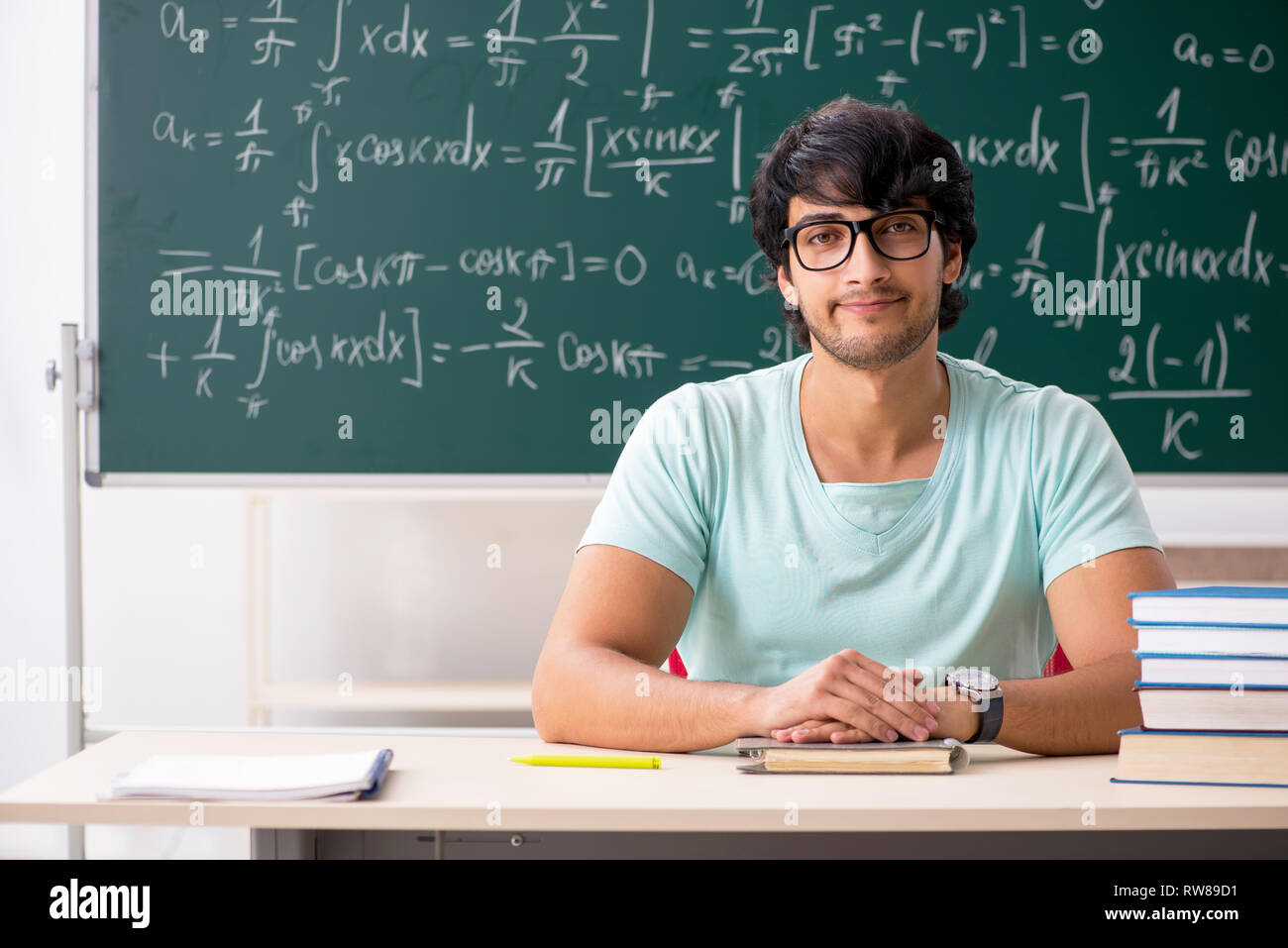 Young male student mathematician in front of chalkboard Stock Photo - Alamy