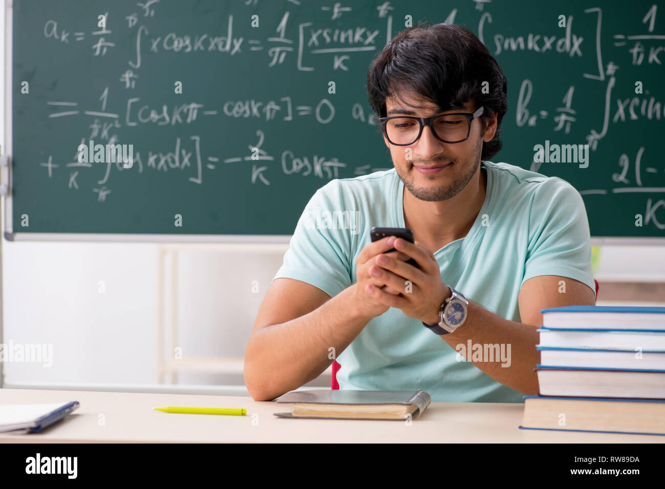 Young male student mathematician in front of chalkboard Stock Photo - Alamy