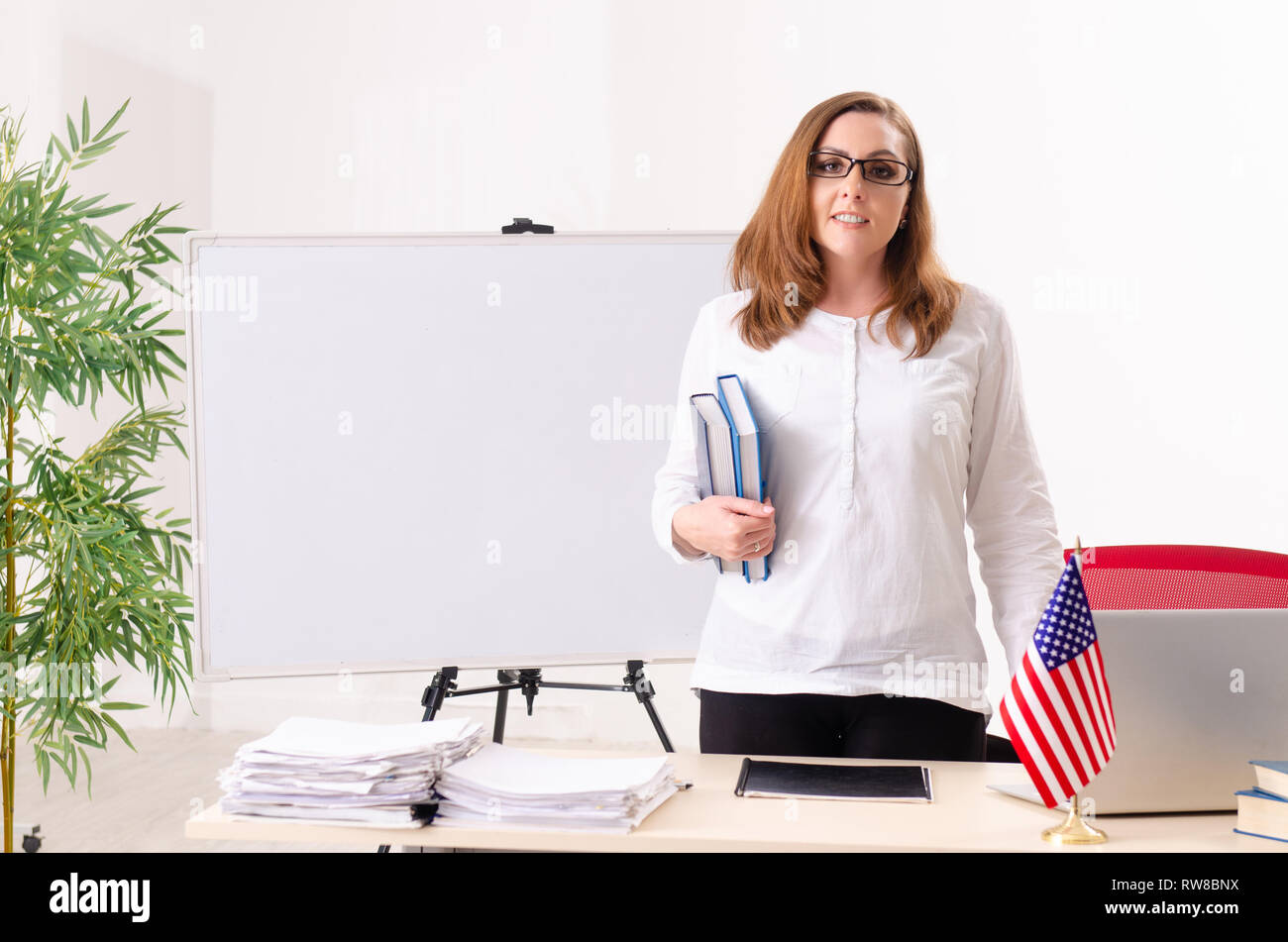 Female english teacher in the classroom Stock Photo - Alamy