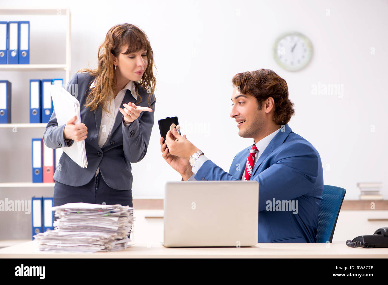 Deaf employee using hearing aid talking to boss Stock Photo - Alamy