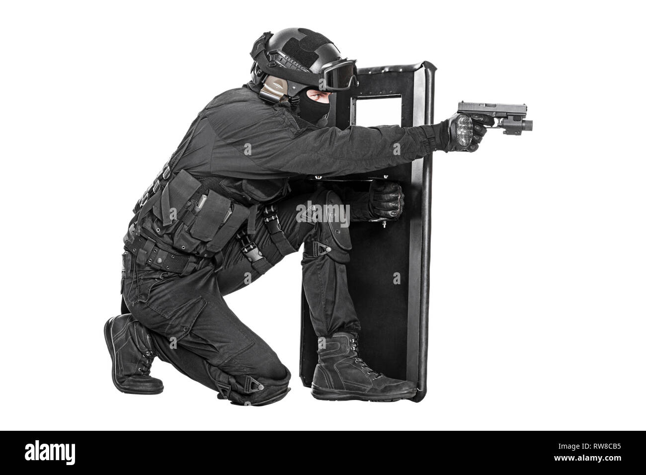Studio shot of SWAT police special forces with pistol hiding behind ...