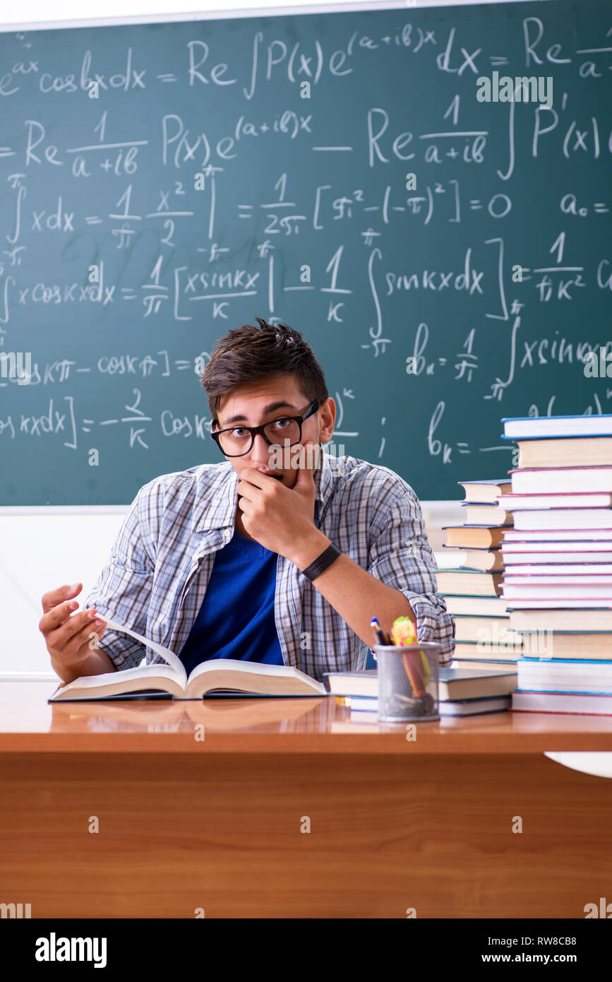 Young male student studying math at school Stock Photo - Alamy
